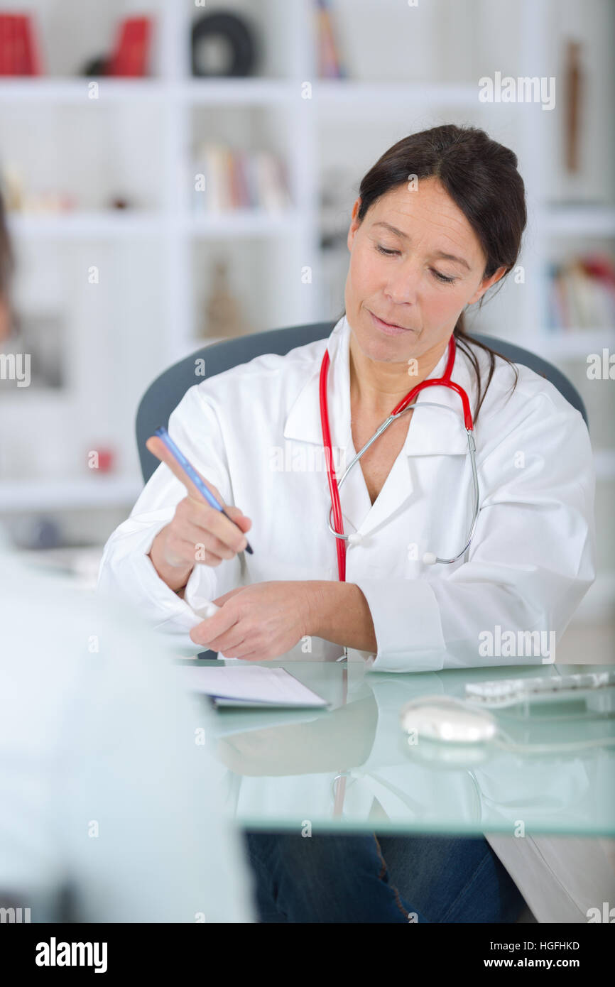 portrait of a beautiful female doctor working in her office Stock Photo ...