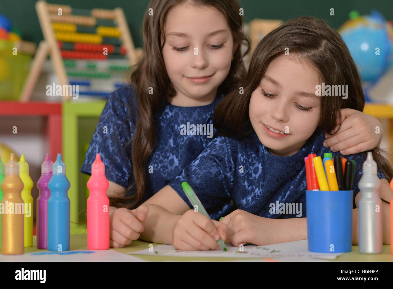 two sisters twins drawing Stock Photo - Alamy