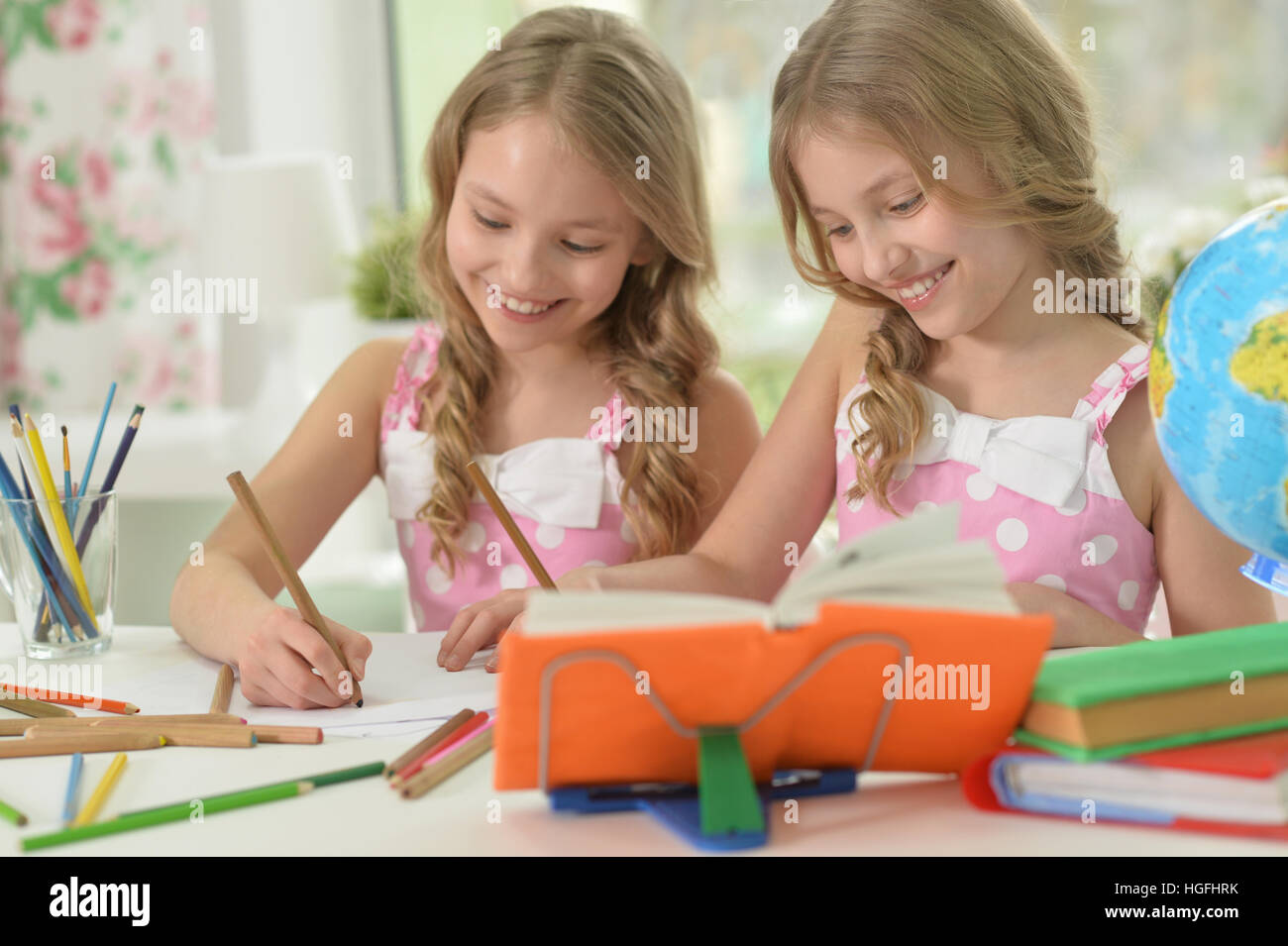 two sisters twins doing homework Stock Photo - Alamy