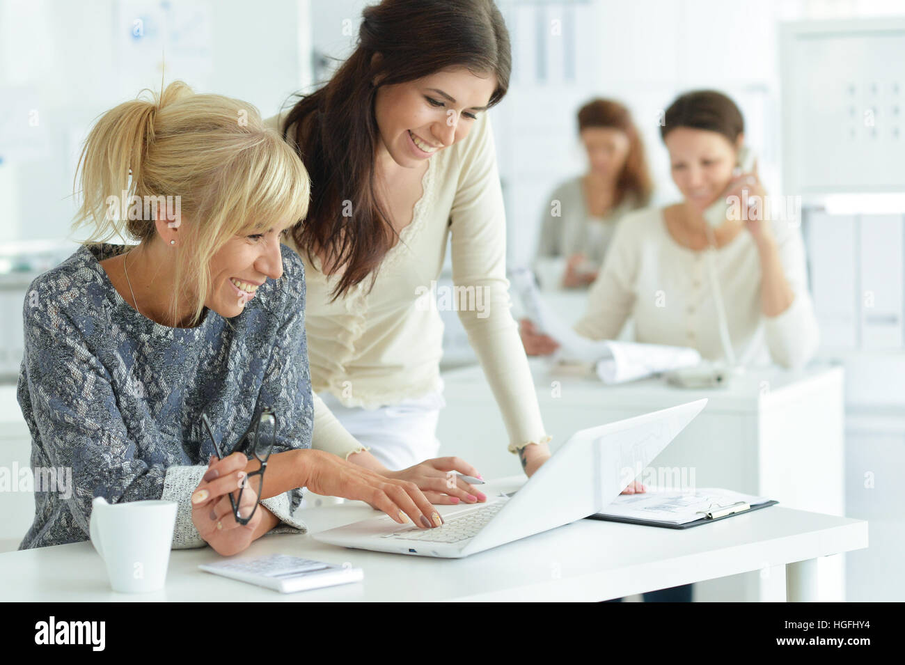 women working together in office Stock Photo - Alamy