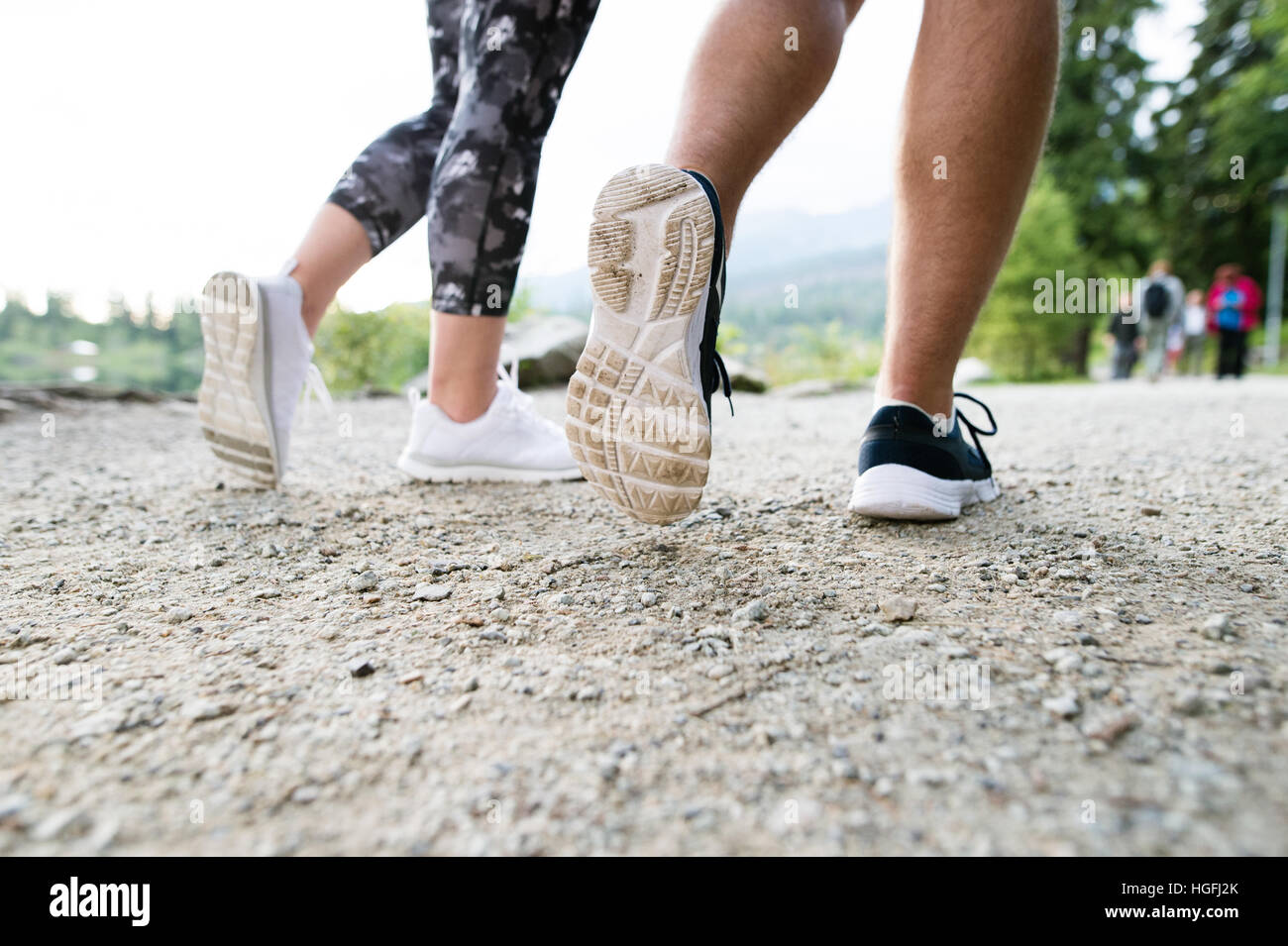 Legs of unrecognizable running couple in sports shoes Stock Photo - Alamy