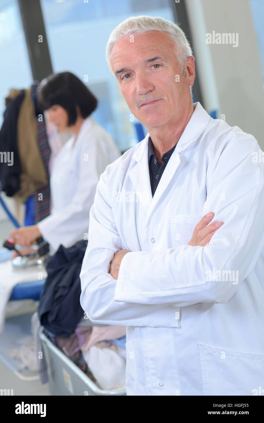Portrait of senior man in white coat Stock Photo - Alamy