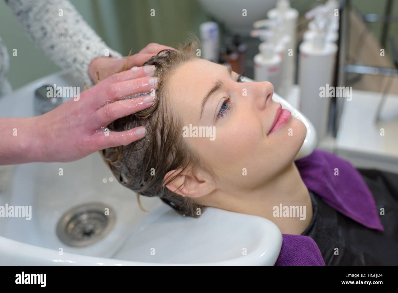 Woman enjoying having hair washed Stock Photo - Alamy