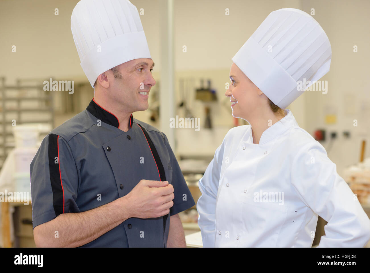 two professionals chefs talking and smiling in the kitchen Stock Photo ...