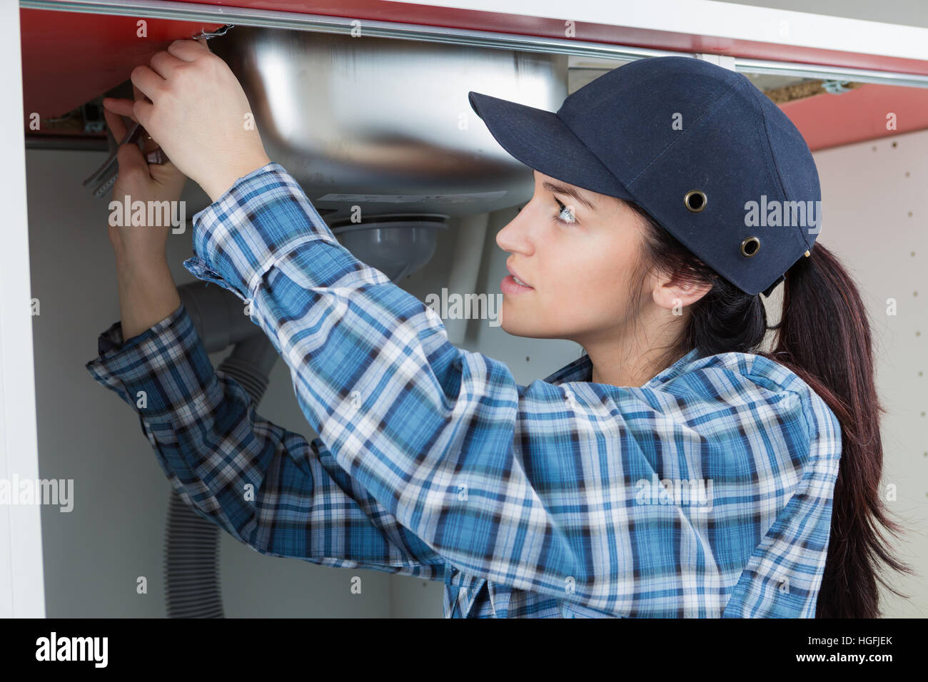 Woman fitting sink Stock Photo - Alamy
