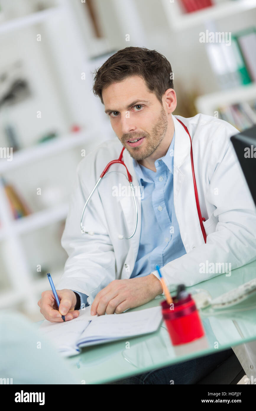 handsome young doctor at work in his office Stock Photo - Alamy