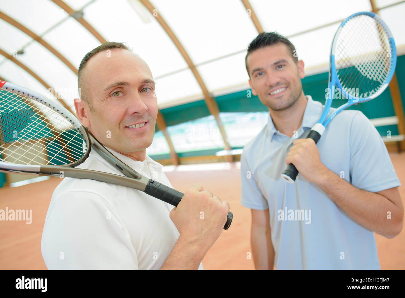 two men with tennis rackets Stock Photo - Alamy