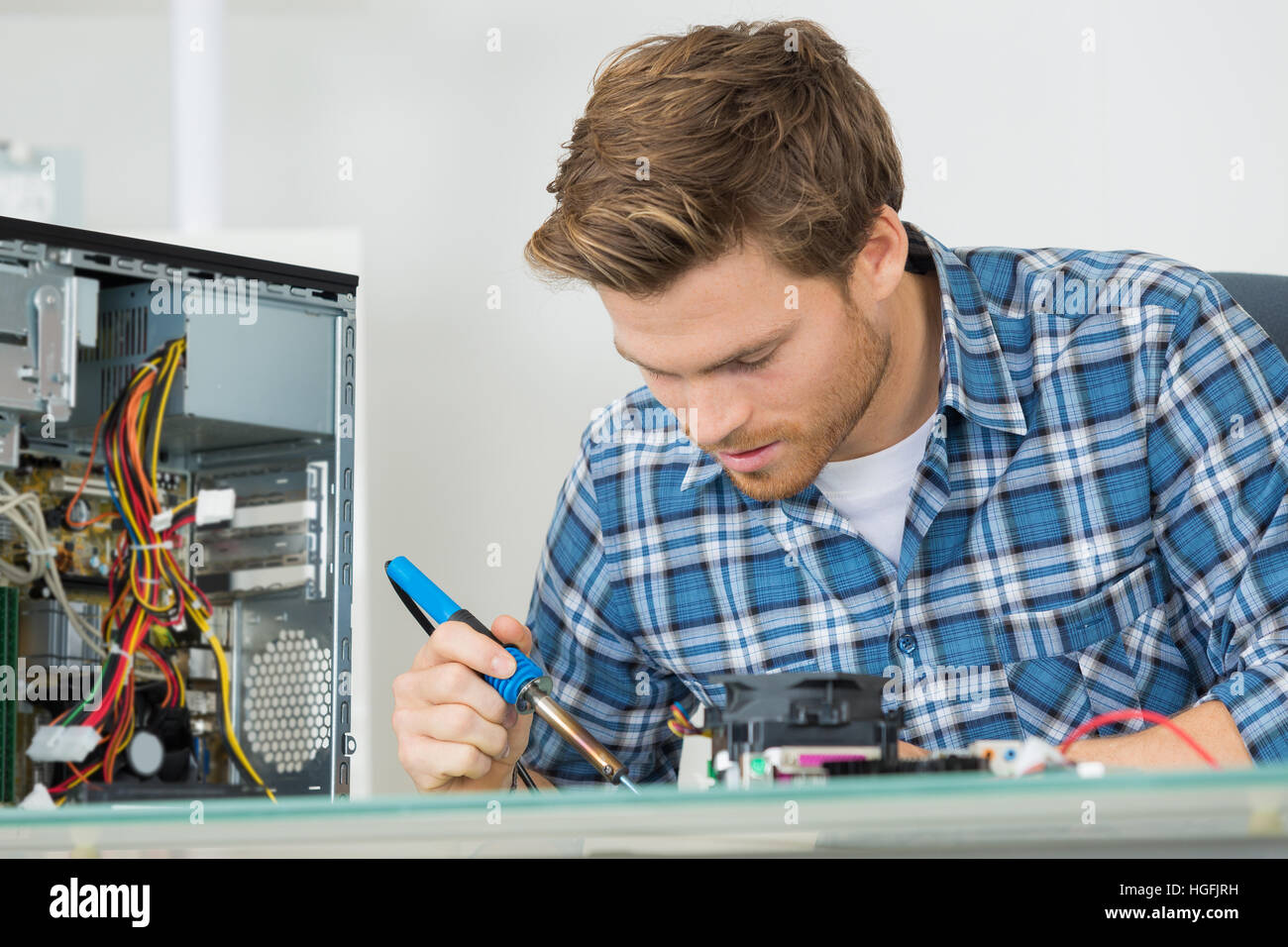 young man fixing computer Stock Photo - Alamy