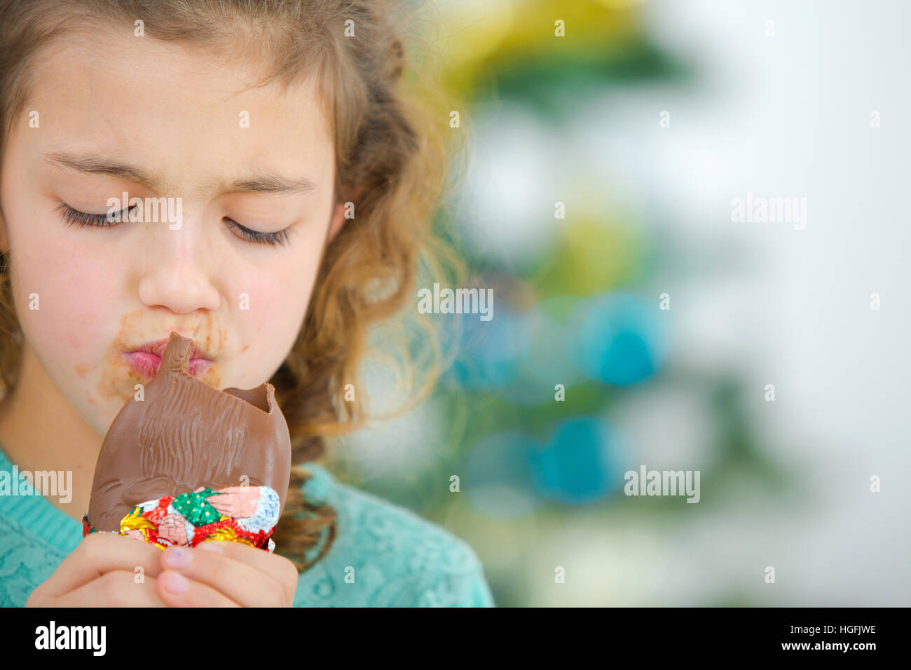 Greedy little girl eating chocolate Stock Photo - Alamy