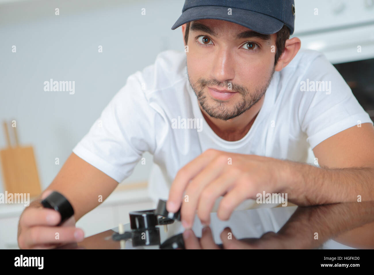 man fixing a cooker's knob Stock Photo - Alamy