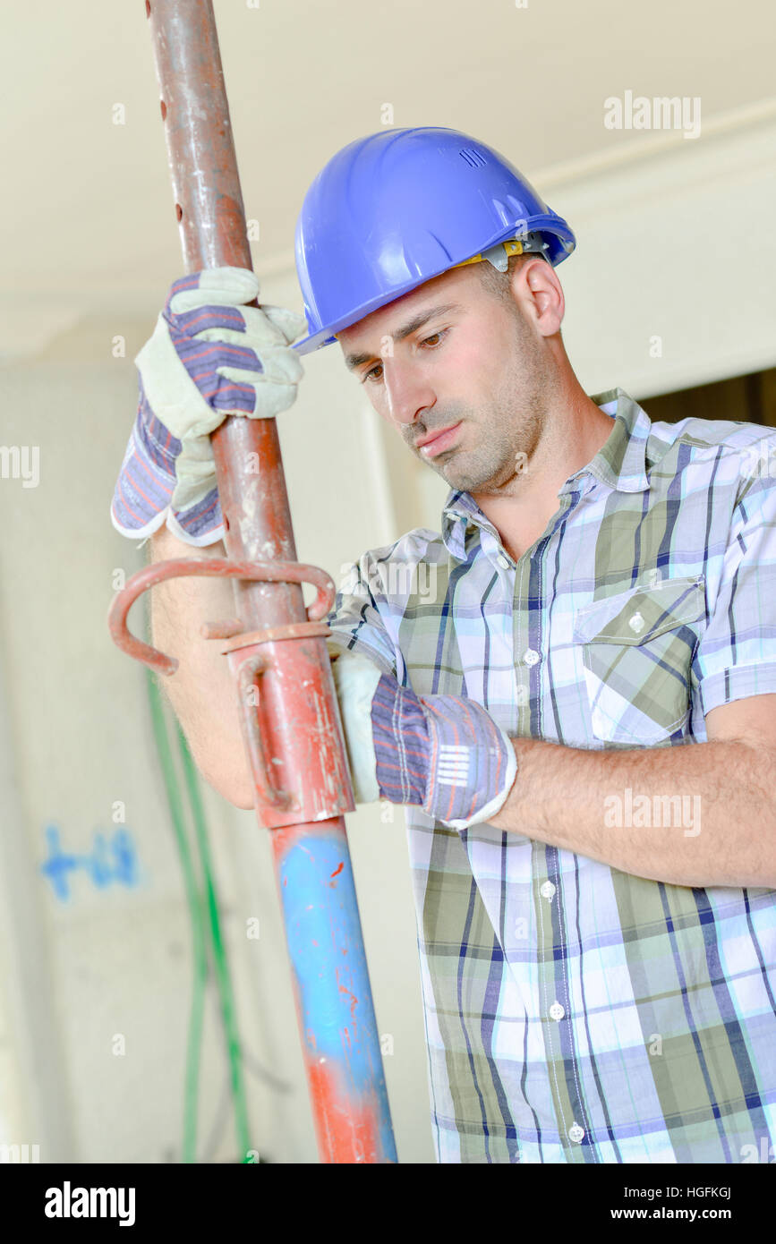 Worker checking a needle beam Stock Photo - Alamy