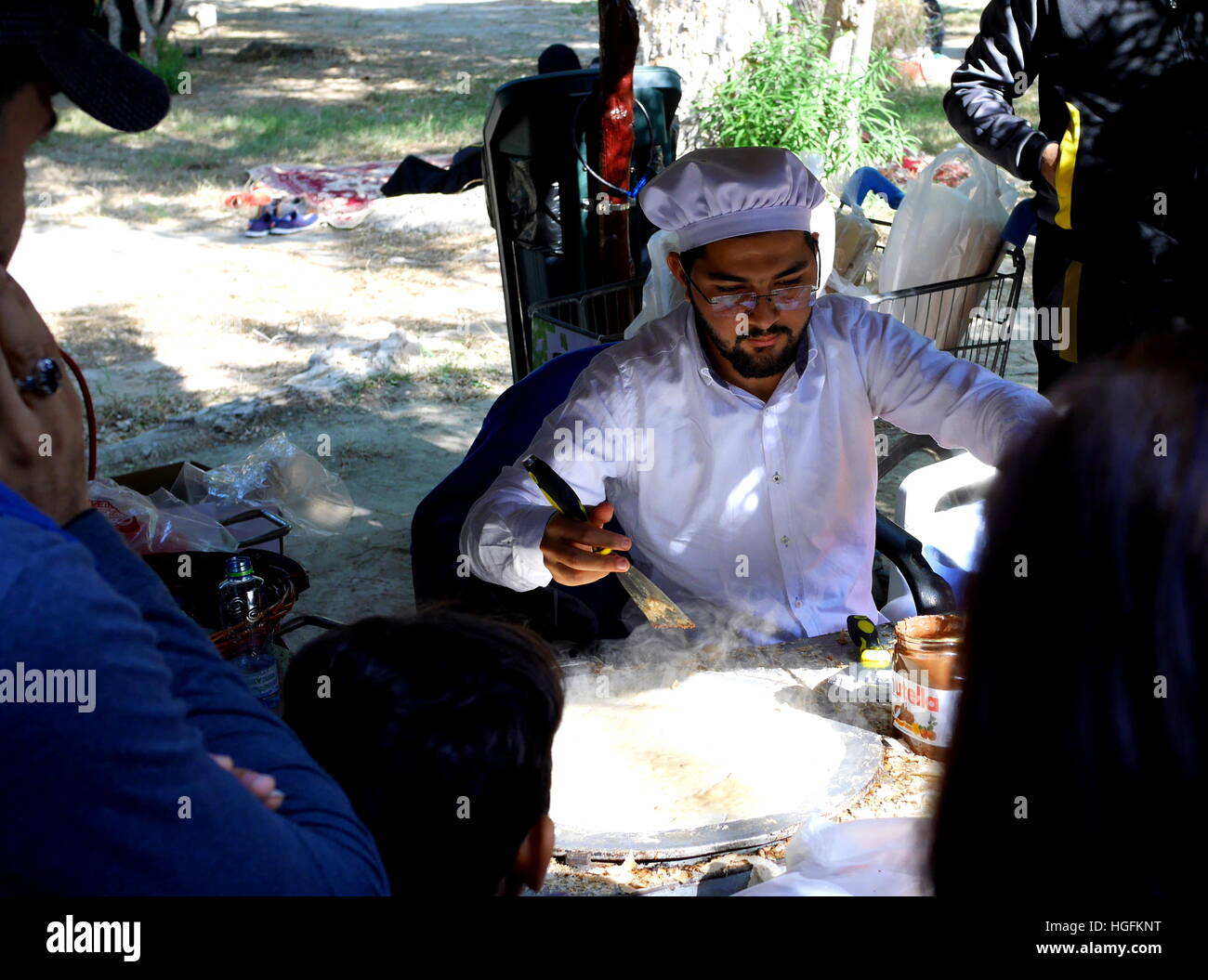 Making pancakes at the farmers' market, held at the botanical garden in ...