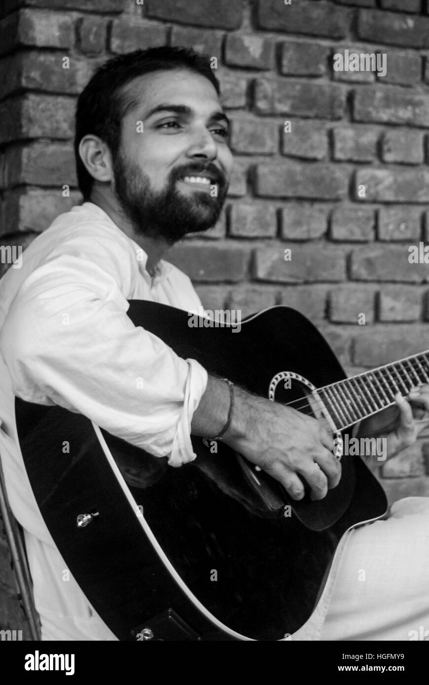 A guitarist playing his instrument Stock Photo - Alamy