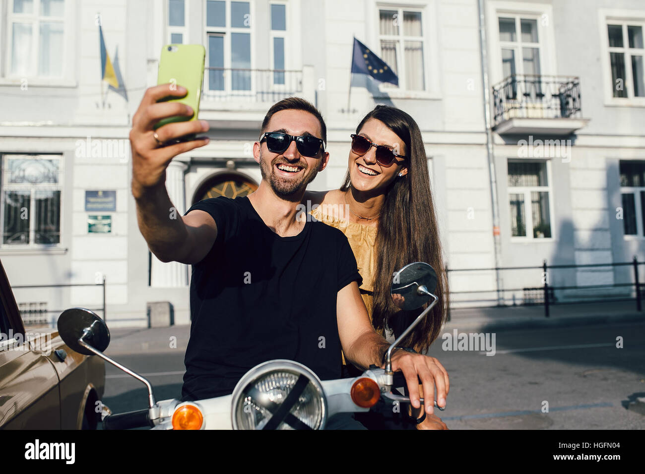Cute couple make selfie on a scooter Stock Photo - Alamy