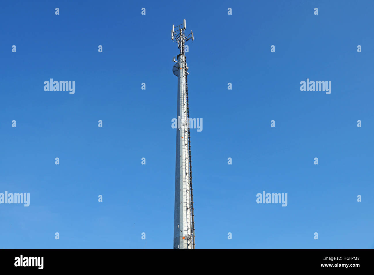 mobile pole behind tree with blue sky back ground ,technology can ...