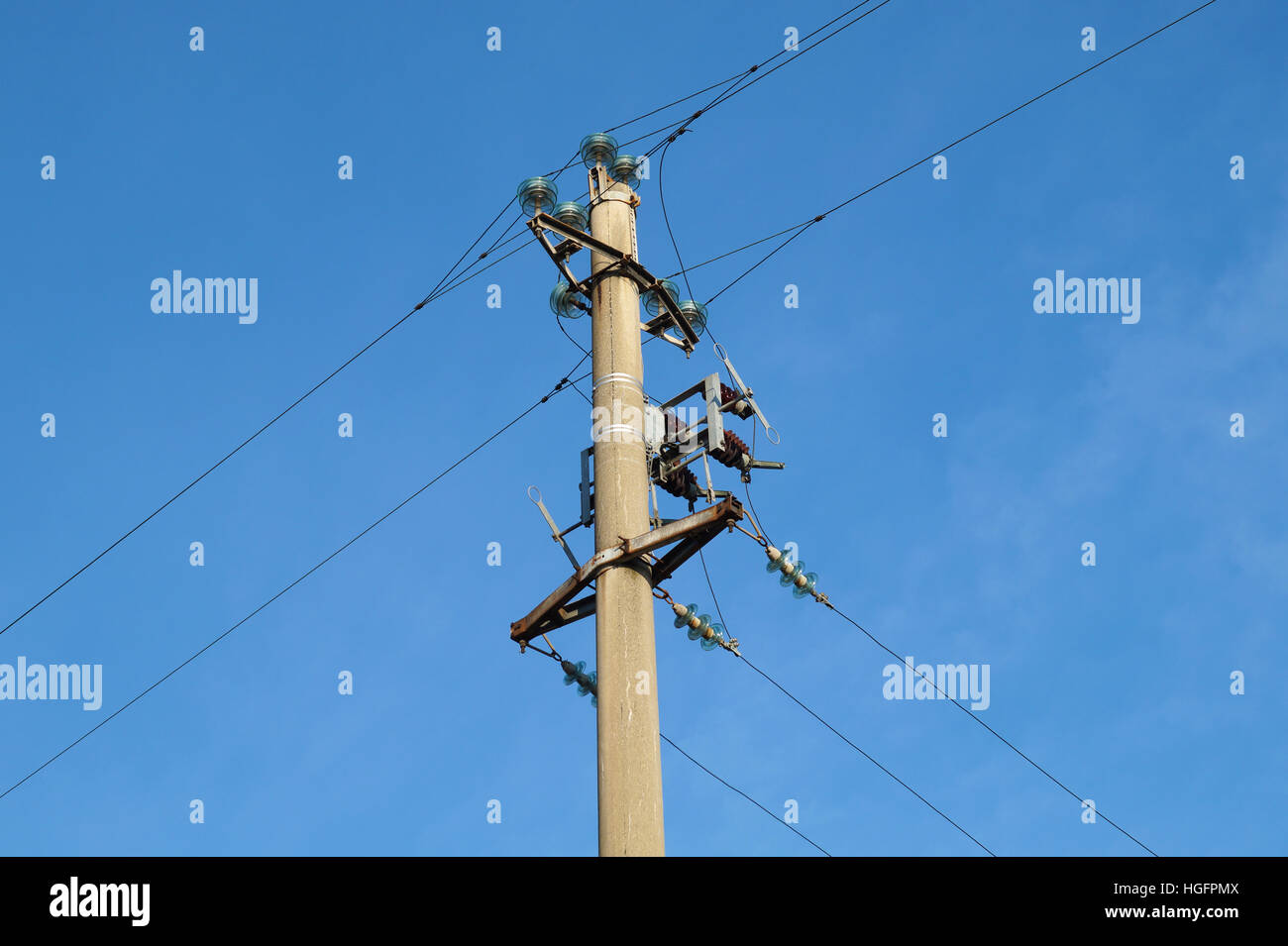 High Voltage Power Lines intersect at a large metal Utility pole in ...
