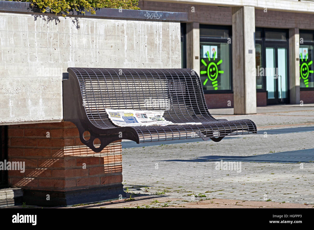 Modern bench at bus stop against leaf wall Stock Photo - Alamy