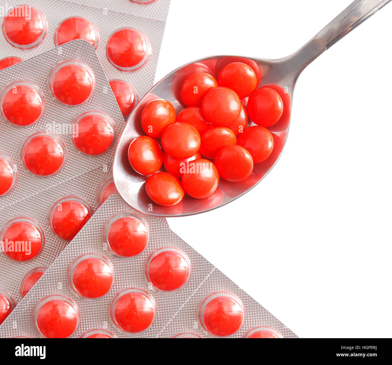 tablets of orange colour in spoon on a white Stock Photo - Alamy