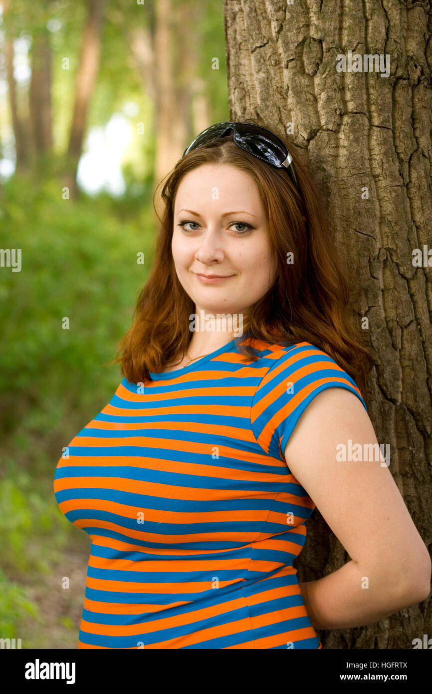 young happy woman standing near tree Stock Photo - Alamy young happy woman standing near tree Stock Photo - Alamy
