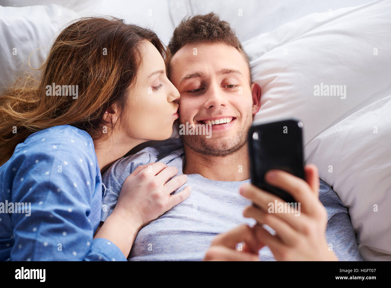 Couple kiss bed hi-res stock photography and images - Alamy