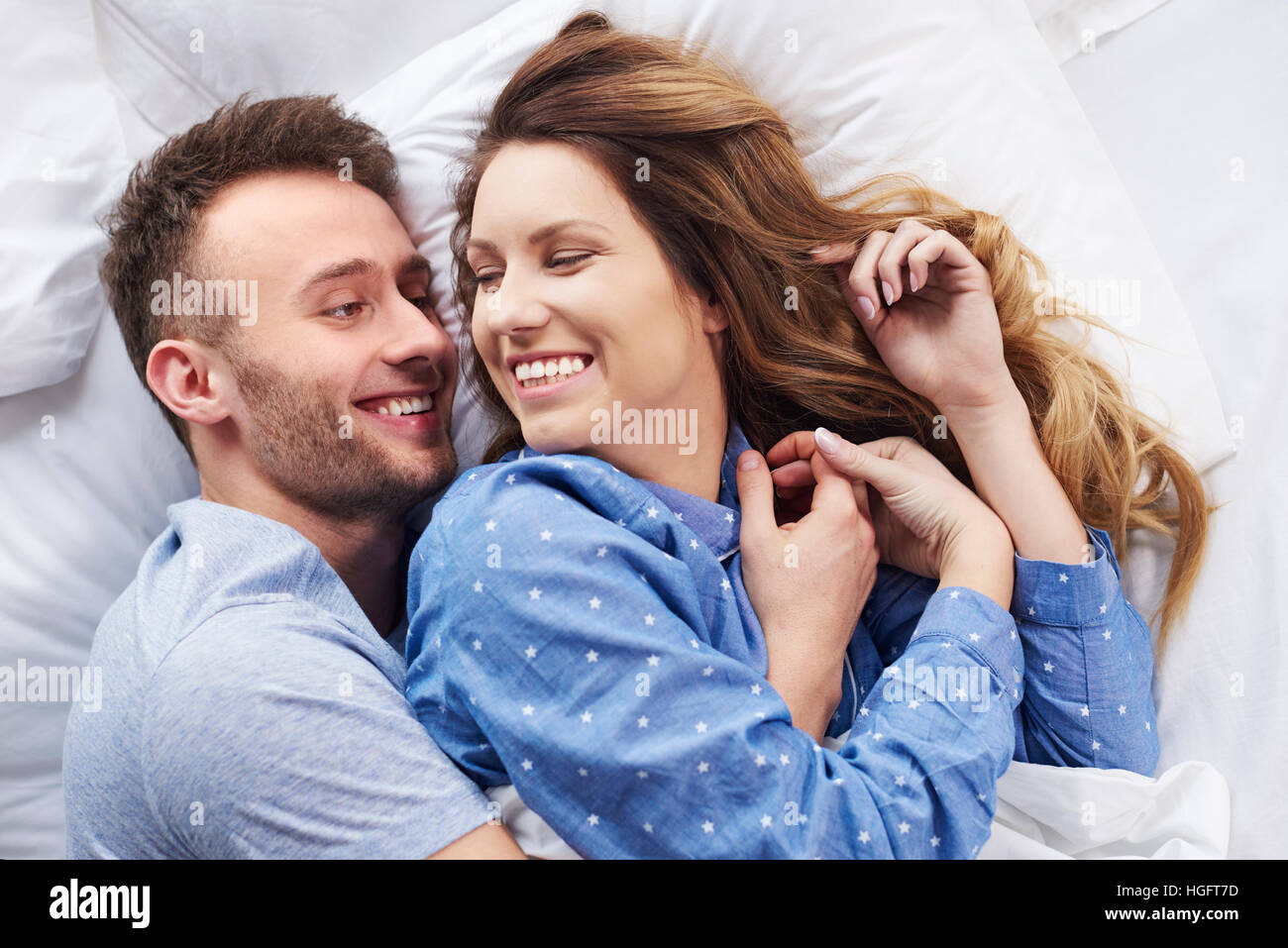 Morning laughs in bed with partner Stock Photo - Alamy