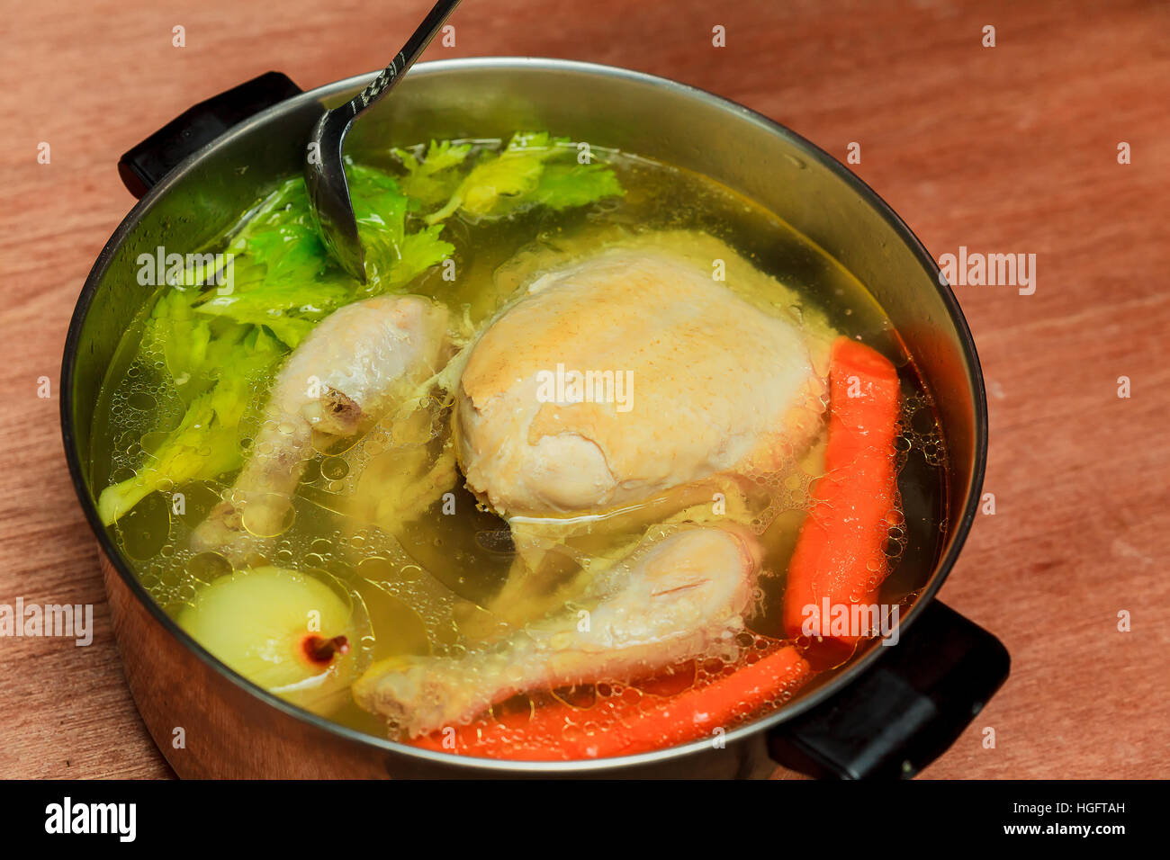 Boil chicken in the pot make chicken broth soup Stock Photo - Alamy