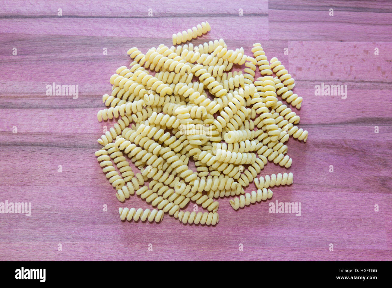 italian pasta fusilli bucati isolated on table wood Stock Photo - Alamy