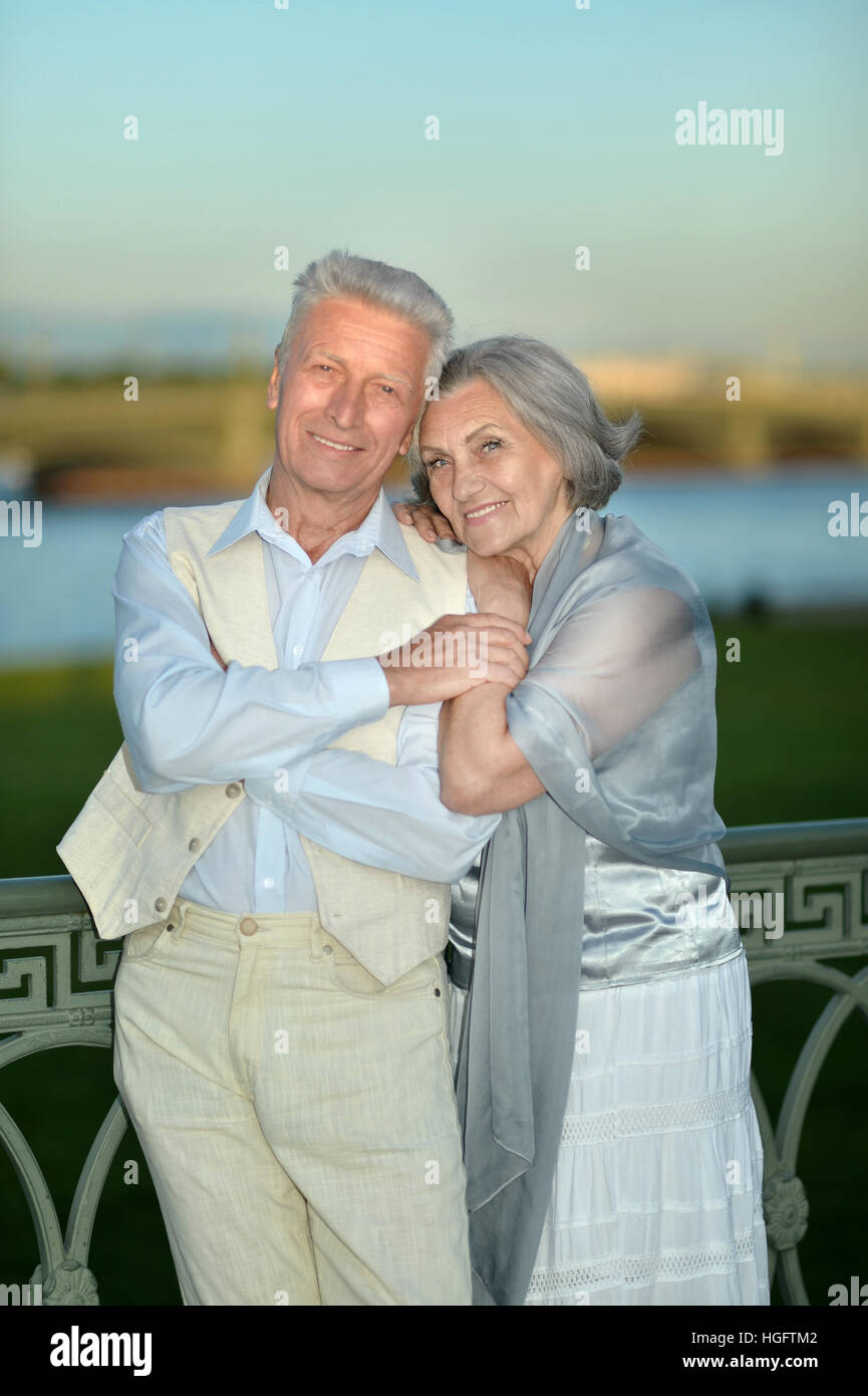 Elderly couple having rest in park Stock Photo - Alamy