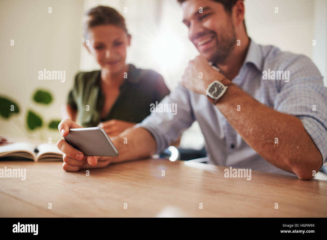 Young happy man smartphone tablet hi-res stock photography and images ...