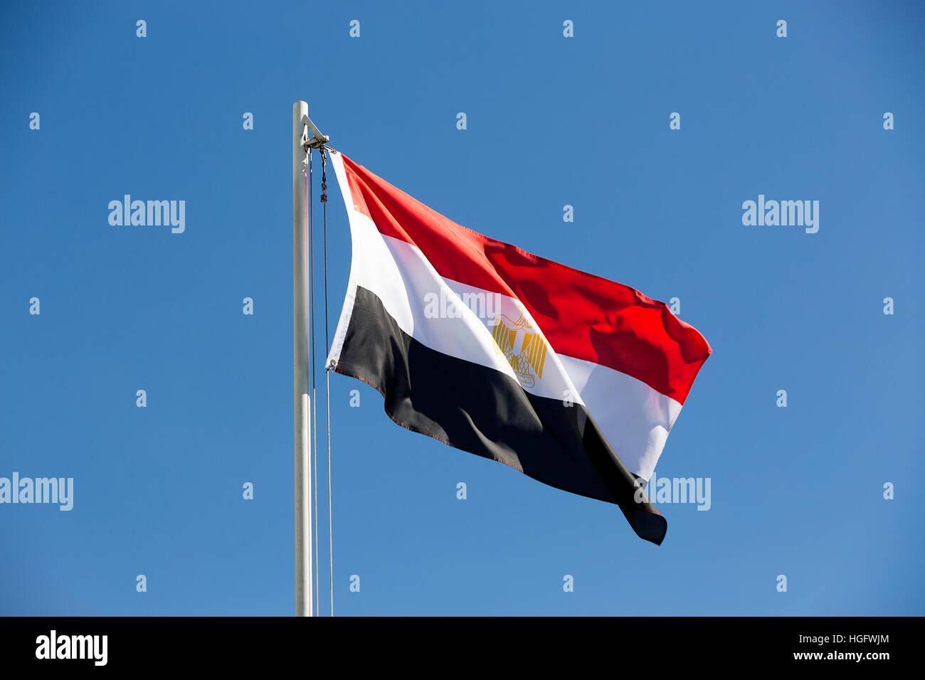 National flag of Egypt on a flagpole in front of blue sky Stock Photo ...