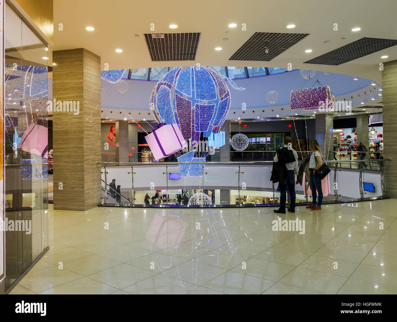Man and girl view showcases and products in a beautiful shopping center ...