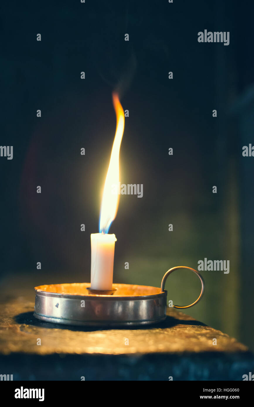 Victorian old wax candle with flickering flame Stock Photo - Alamy
