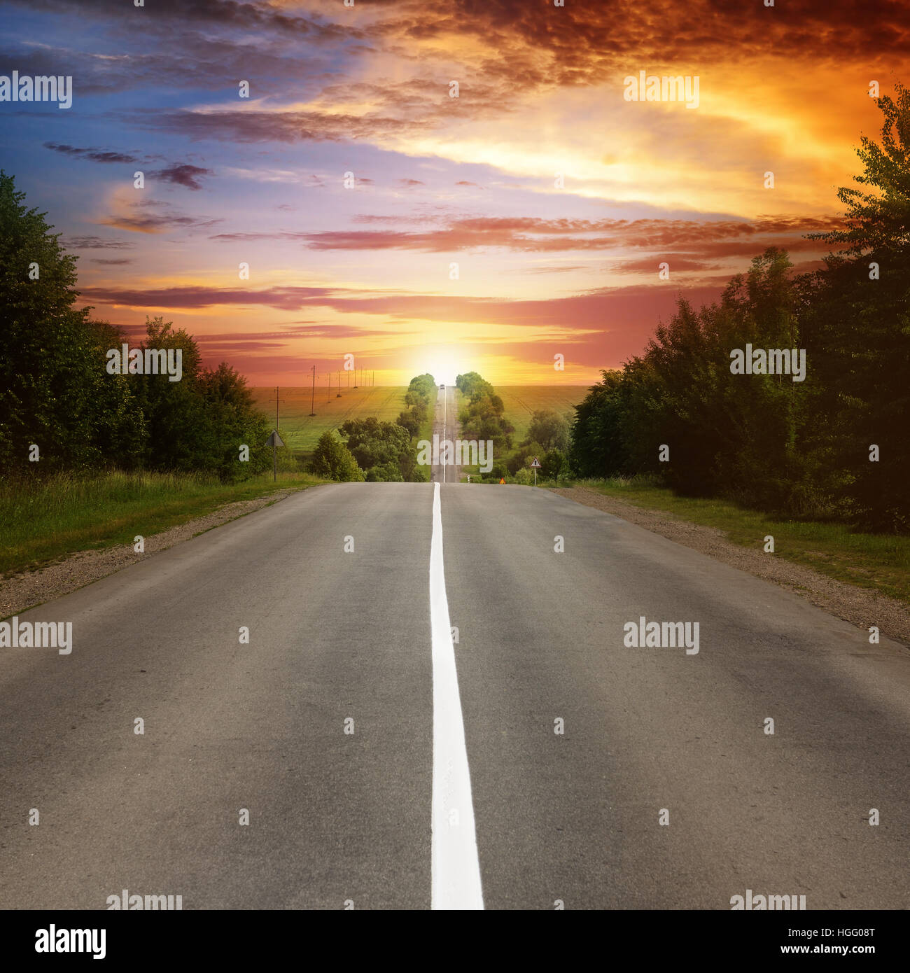 road between trees and beautiful sunset Stock Photo - Alamy