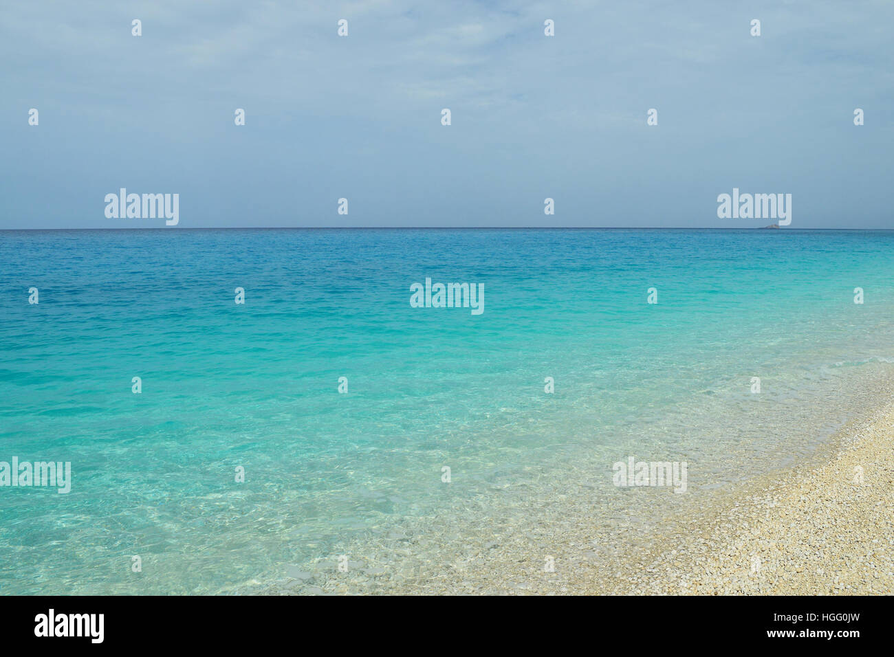 Calm tropical sea with limpid emerald water and bright sandy beach ...