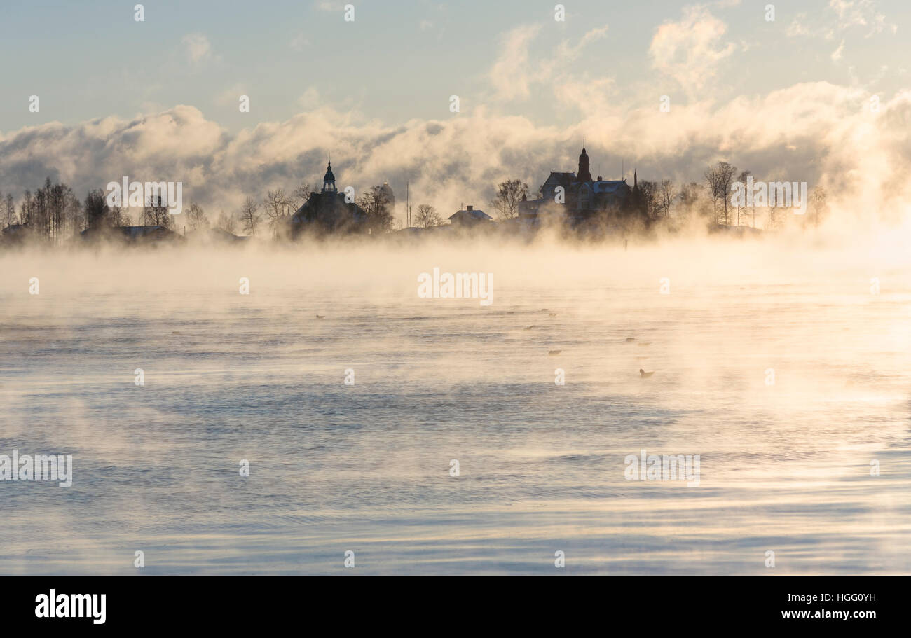 Island with buildings in a steaming ocean Stock Photo - Alamy