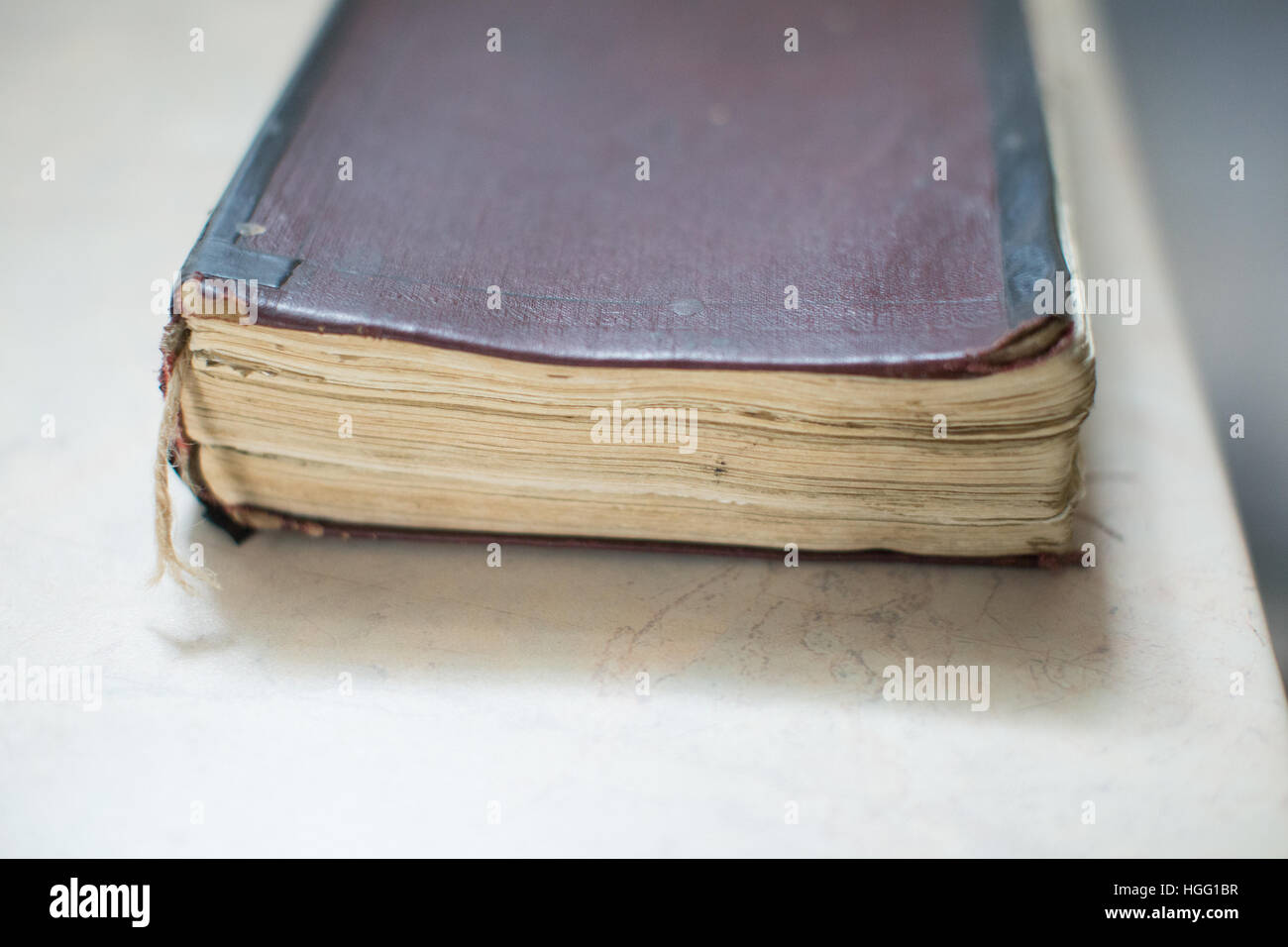 Vintage, antiquarian old book close up on white table Stock Photo - Alamy