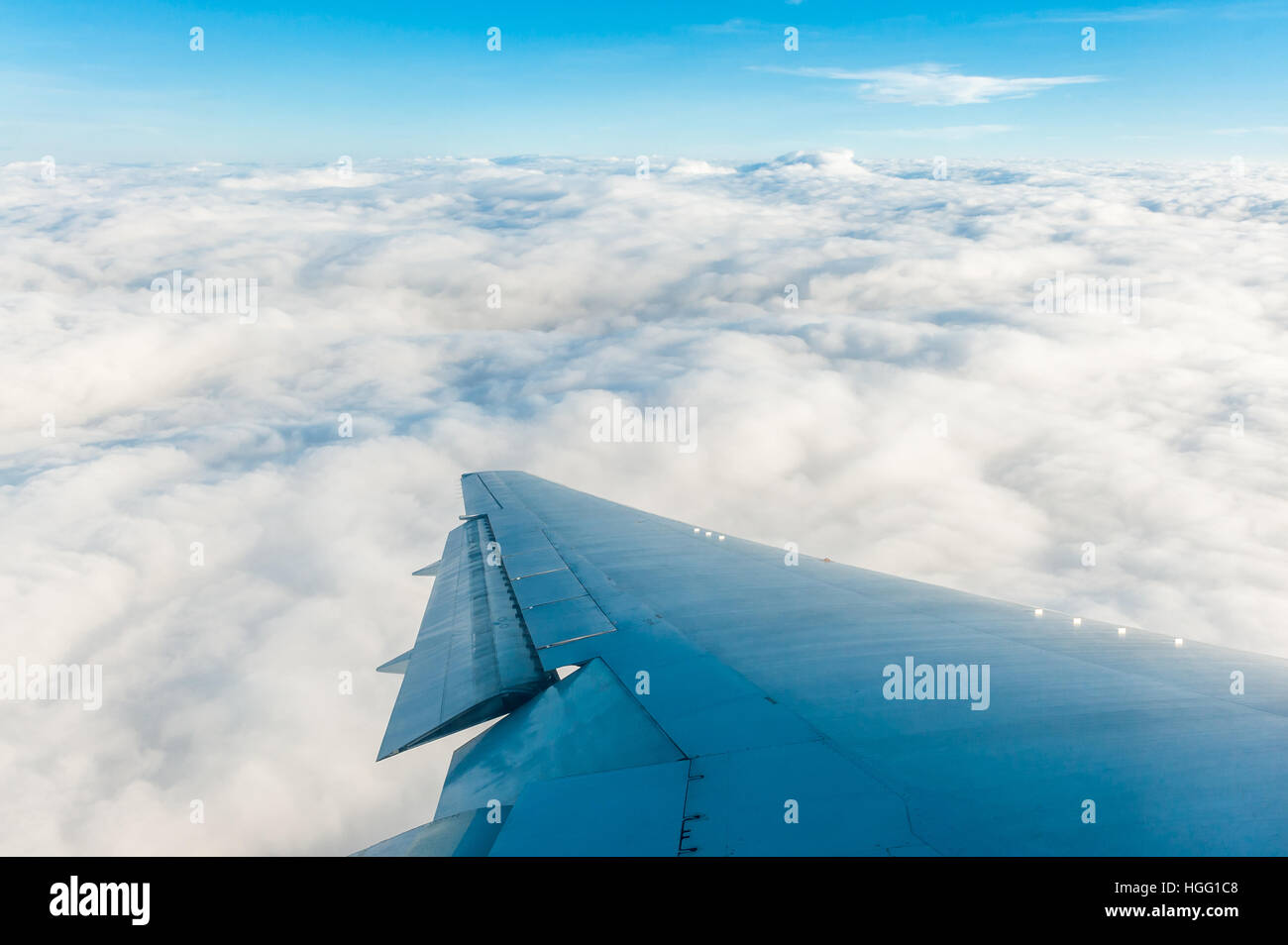 Plane flying over clouds Stock Photo - Alamy