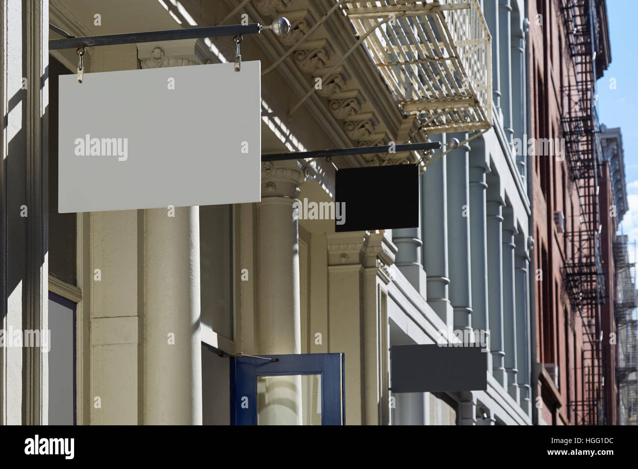 Typical buildings with blank store signs in a sunny day in New York ...