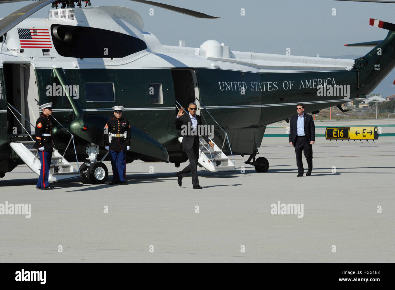 President Barack Obama waves his hand as he leaves Marine One walking ...