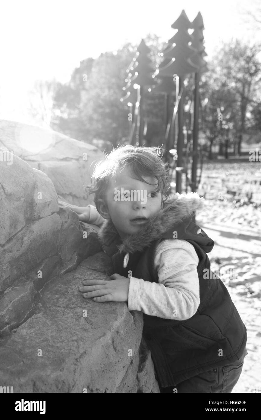 Young child climbing around park in the Fall Stock Photo - Alamy
