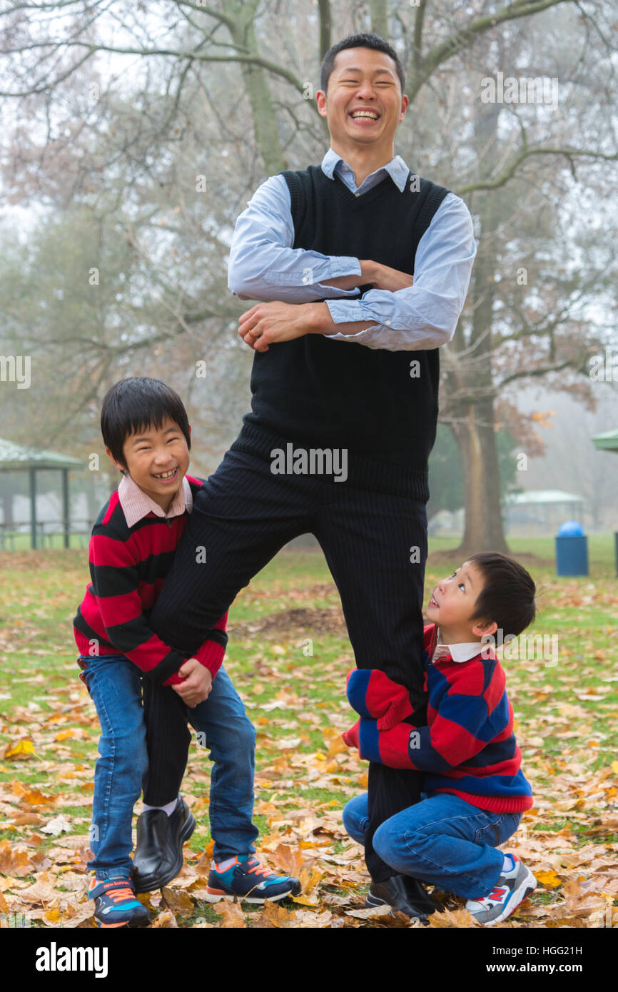 Father and sons in the park in the Fall Stock Photo - Alamy