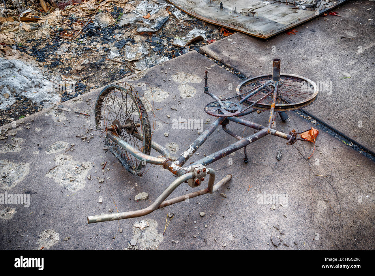 A child's bicycle that has been destroyed by a forest fire in ...