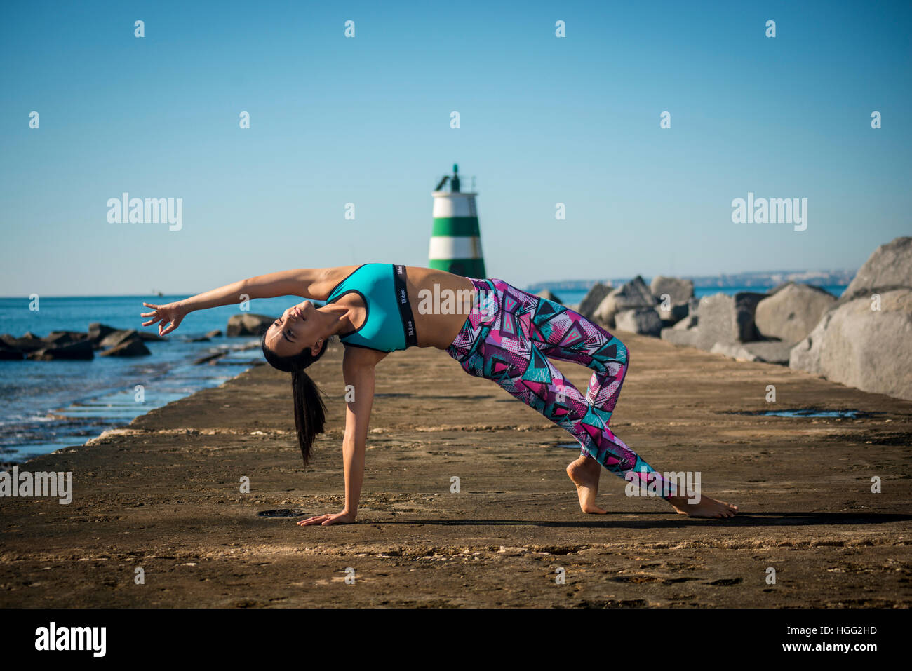 woman doing yoga by the sea Stock Photo - Alamy