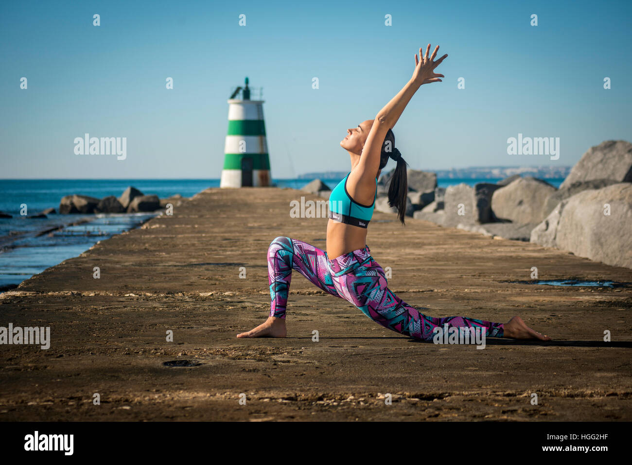 woman doing yoga by the sea Stock Photo - Alamy