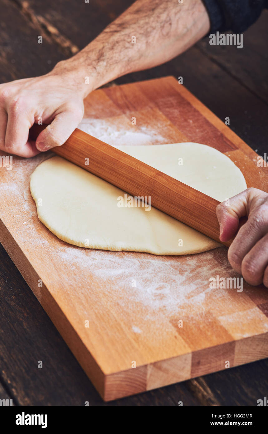 Making handmade pasta with wooden rolling pin Stock Photo - Alamy