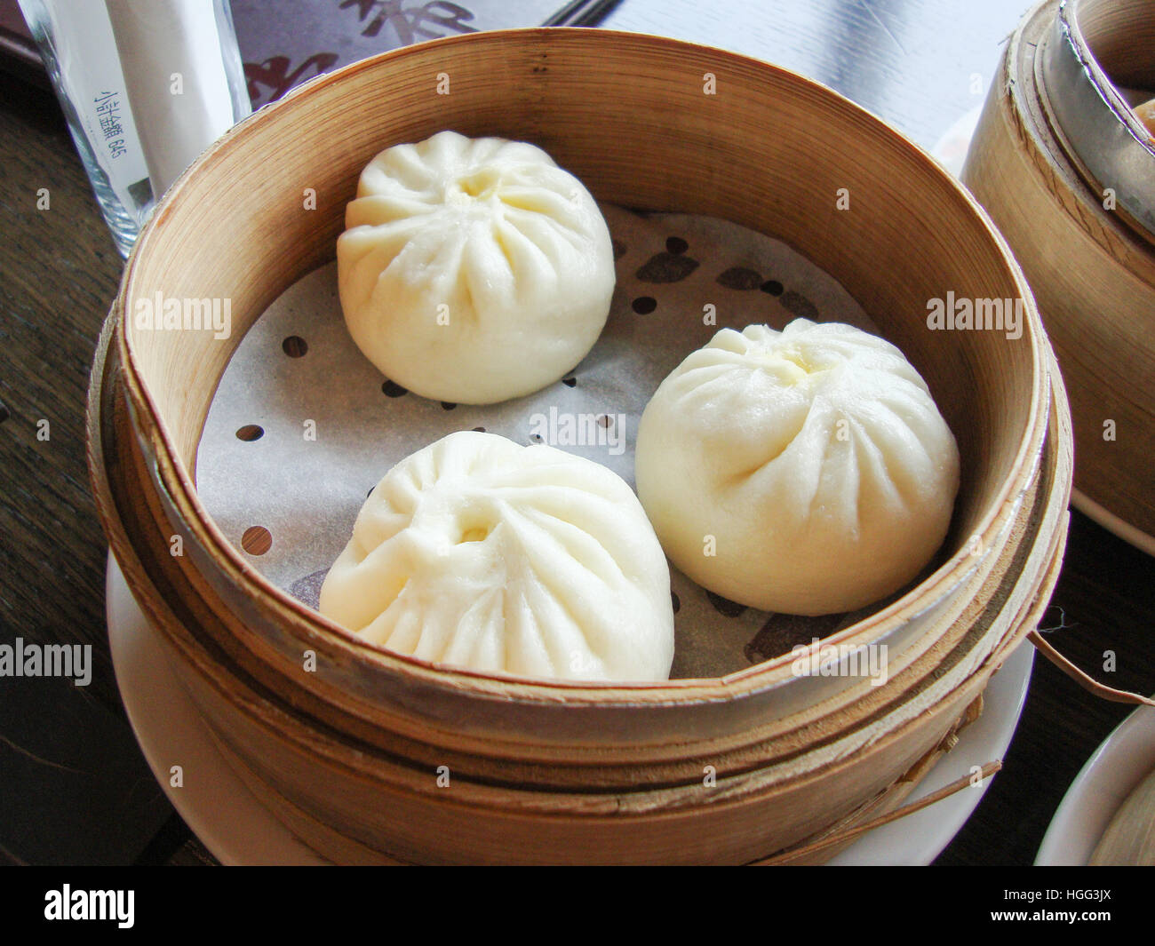 Steamed buns in a bamboo basket Stock Photo - Alamy