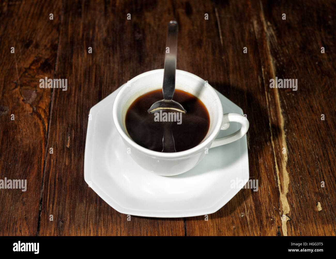 Spoon standing upright in a cup of strong coffee Stock Photo - Alamy