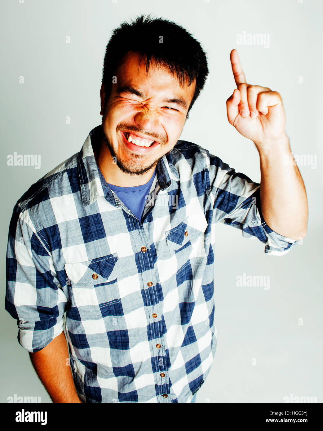 young cute asian man on white background gesturing emotional, pointing ...
