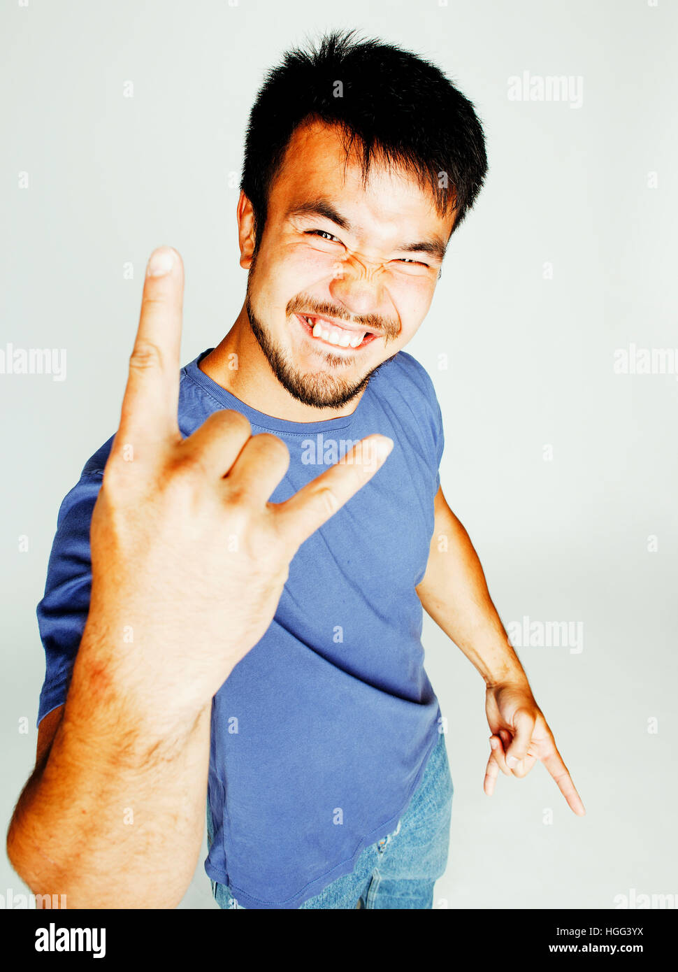 young cute asian man on white background gesturing emotional, pointing ...