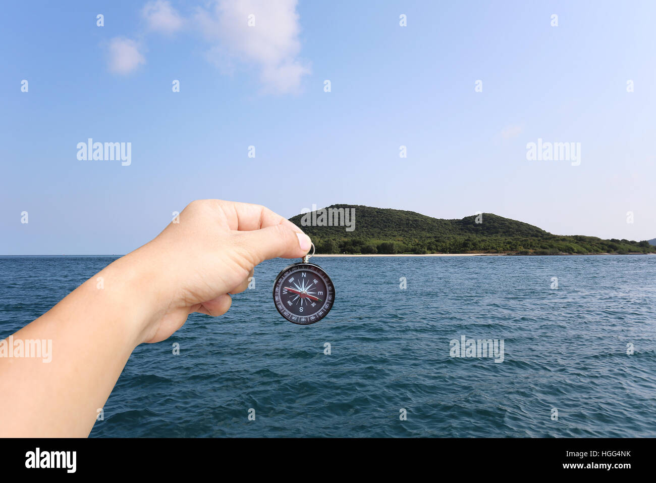 Hand of man holding a compass and sea island view,concept of journey at ...
